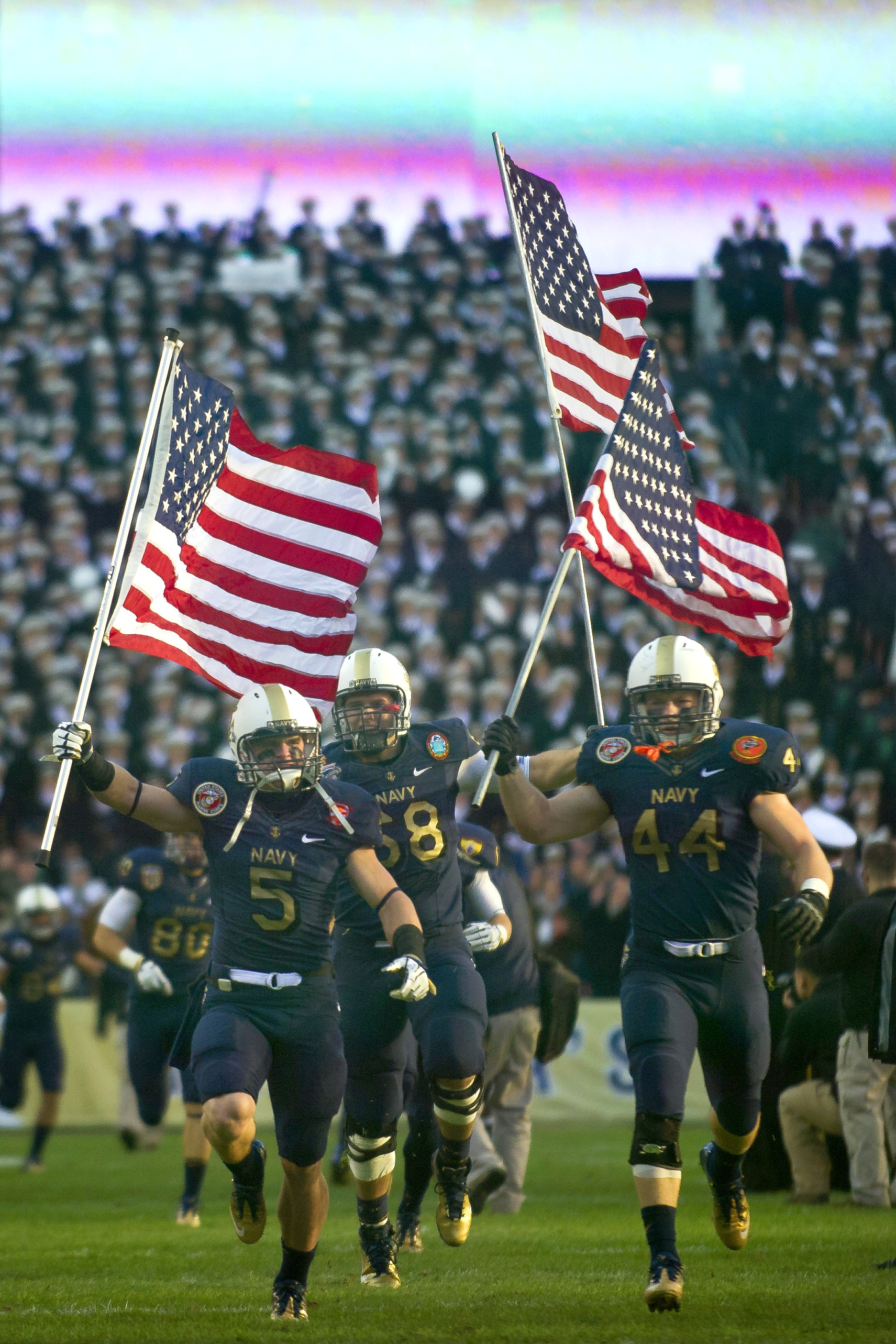 Navy Midshipmen charge the field to kick off the 112th Army-Navy ...