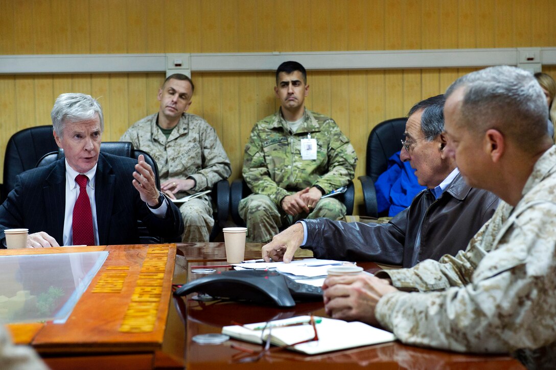 U.S. Defense Secretary Leon E. Panetta listens as U.S. Ambassador to ...
