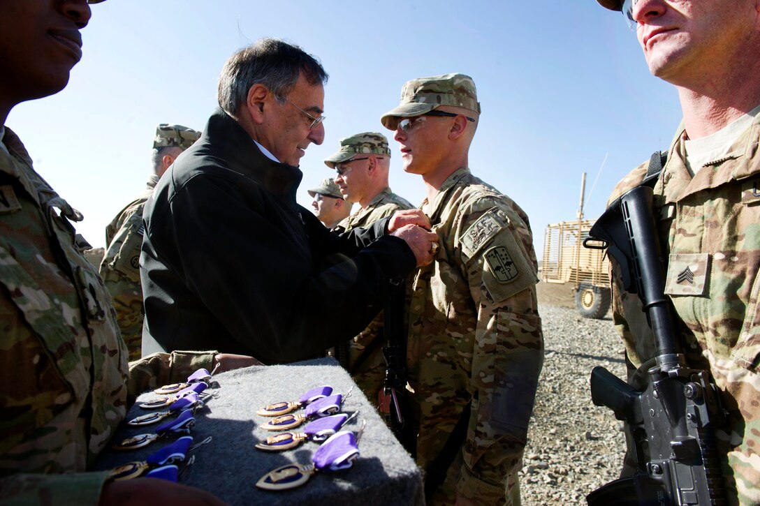U.S. Defense Secretary Leon E. Panetta presents a Purple Heart to a ...