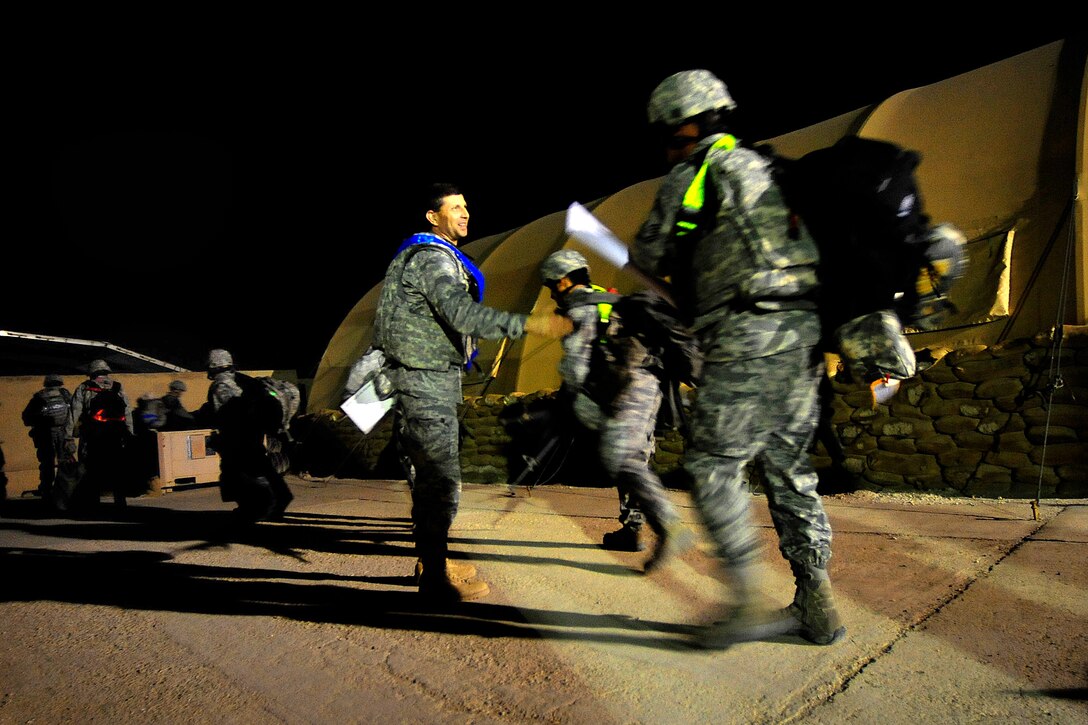 U.S. Air Force Col. Ted Mathews shakes the hand of all the U.S. airmen ...