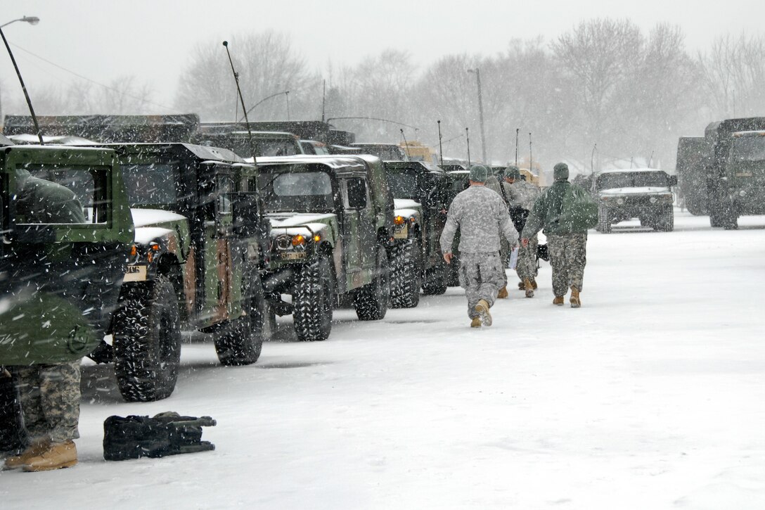 U.S. Army soldiers prepare to patrol the snowy roads and provide ...
