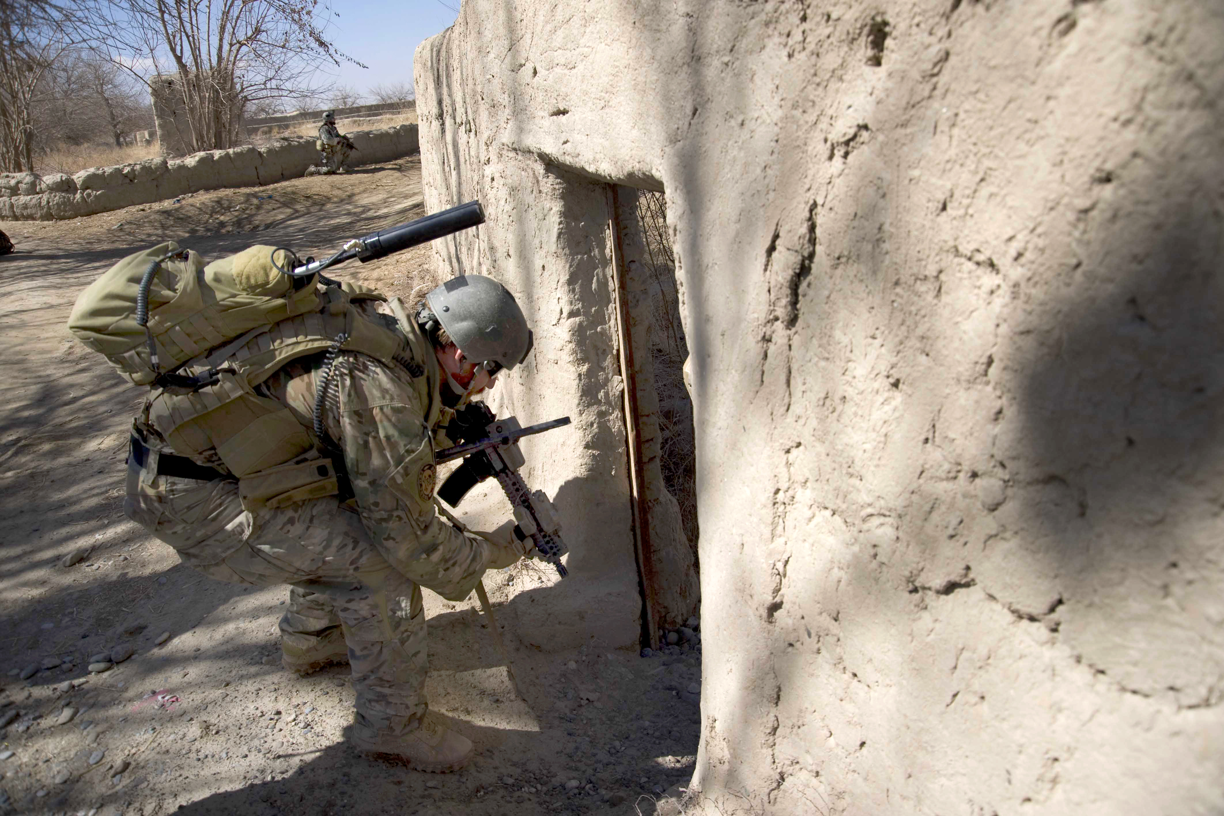 A U.S. Special Forces sergeant enters an abandoned compound in Kandahar ...