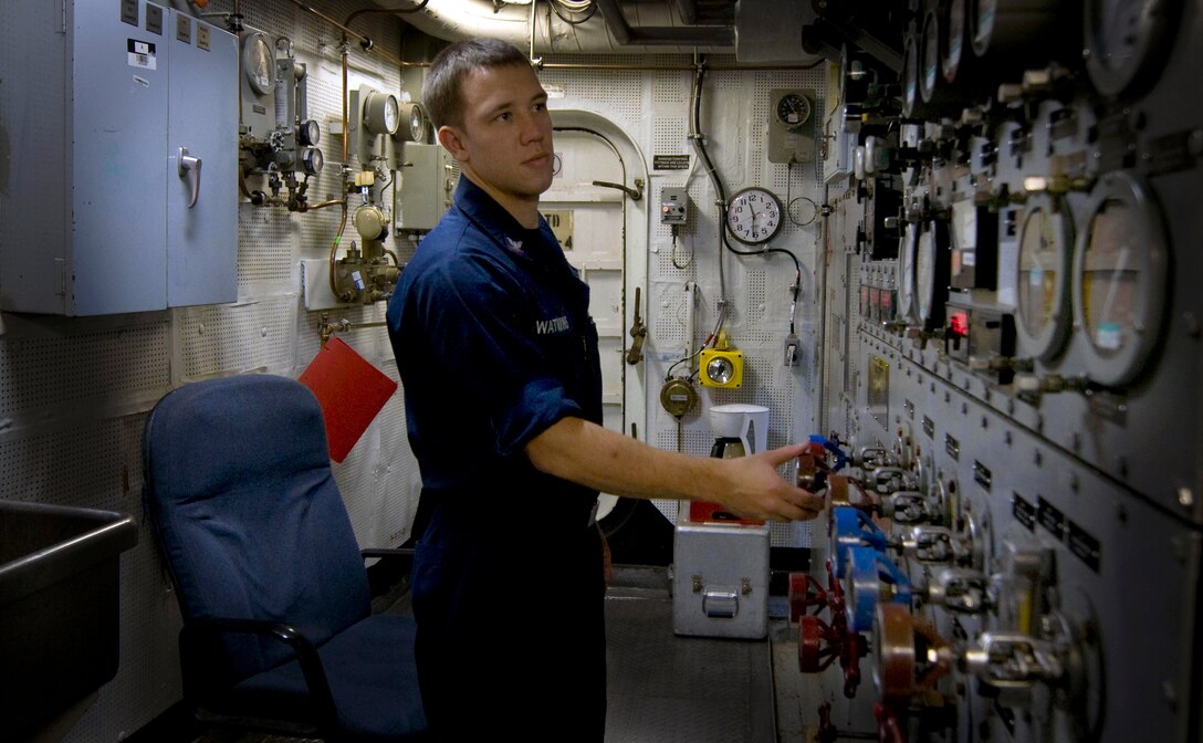 U.S. Navy Petty Officer 3rd Class Tyrell Watkins checks temperature ...