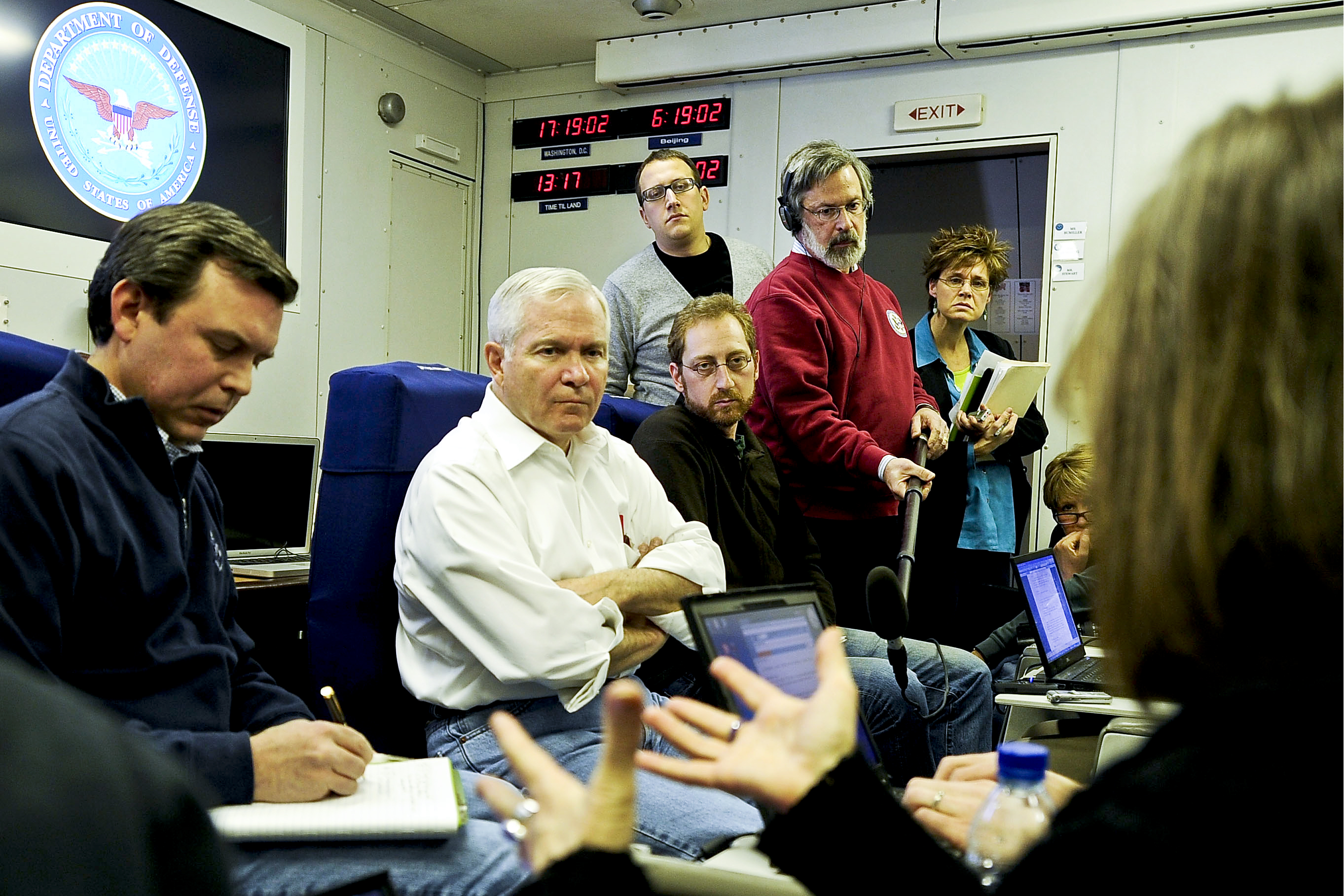 U.S. Defense Secretary Robert M. Gates and members of his staff listen ...
