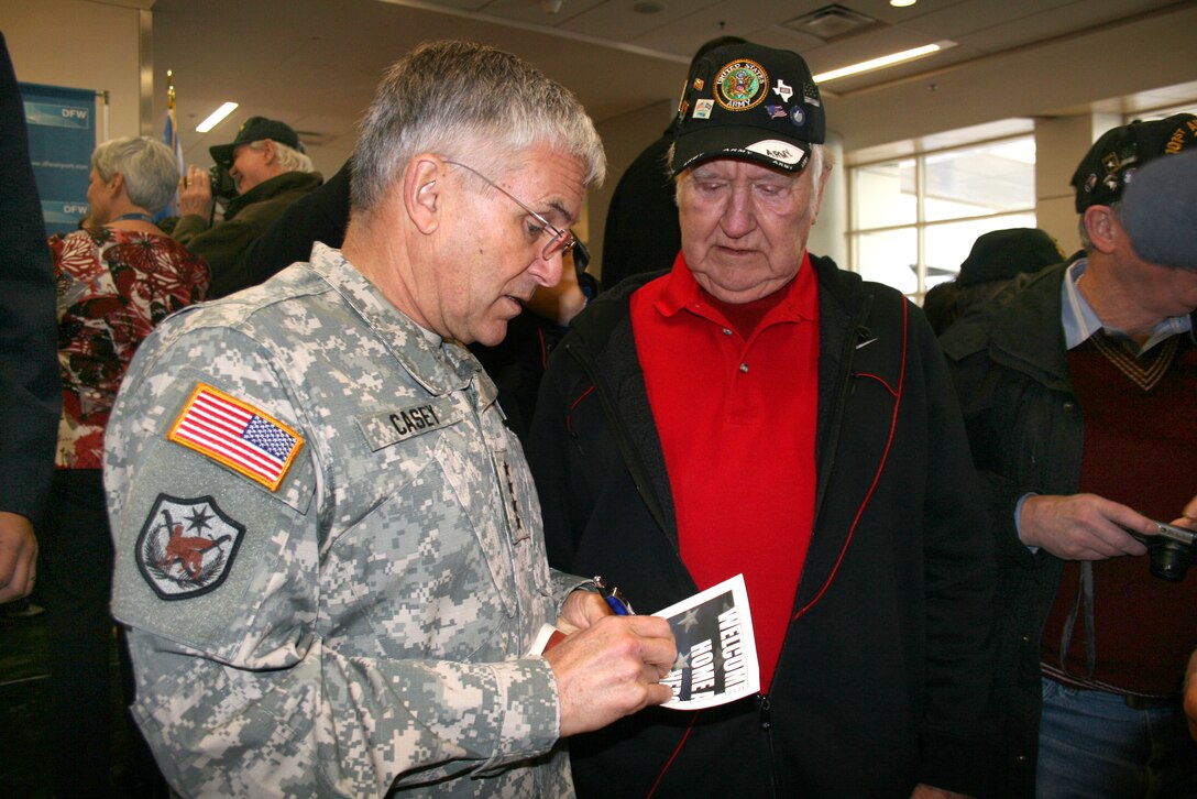 U.S. Army Chief of Staff Gen. George W. Casey Jr. signs a welcome home ...