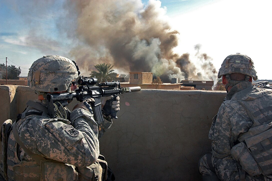 Soldiers fight on the rooftops of Sufeit, a village in Diyala Province ...