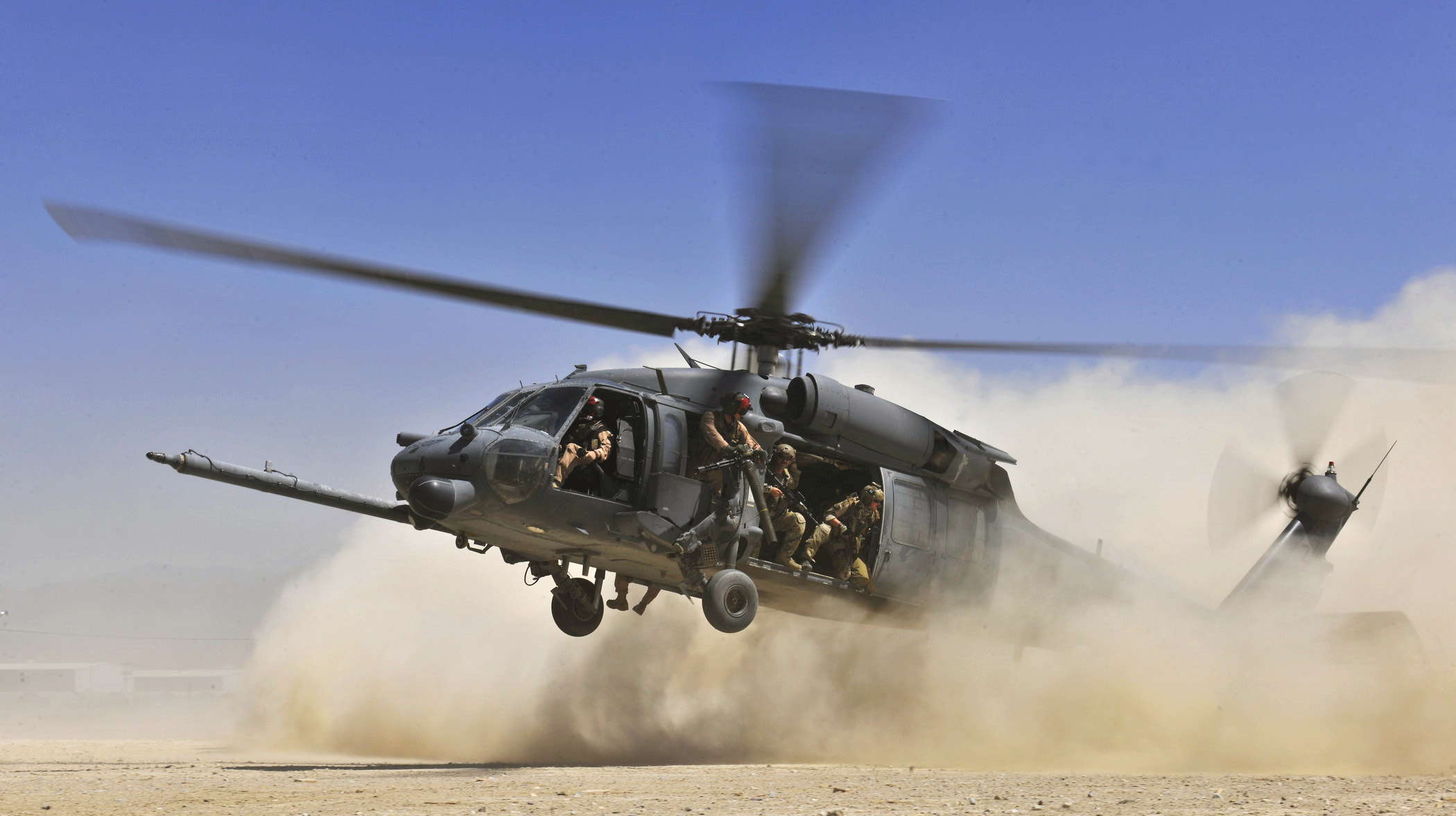 An HH-60G Pave Hawk helicopter carrying combat search and rescue Airmen ...