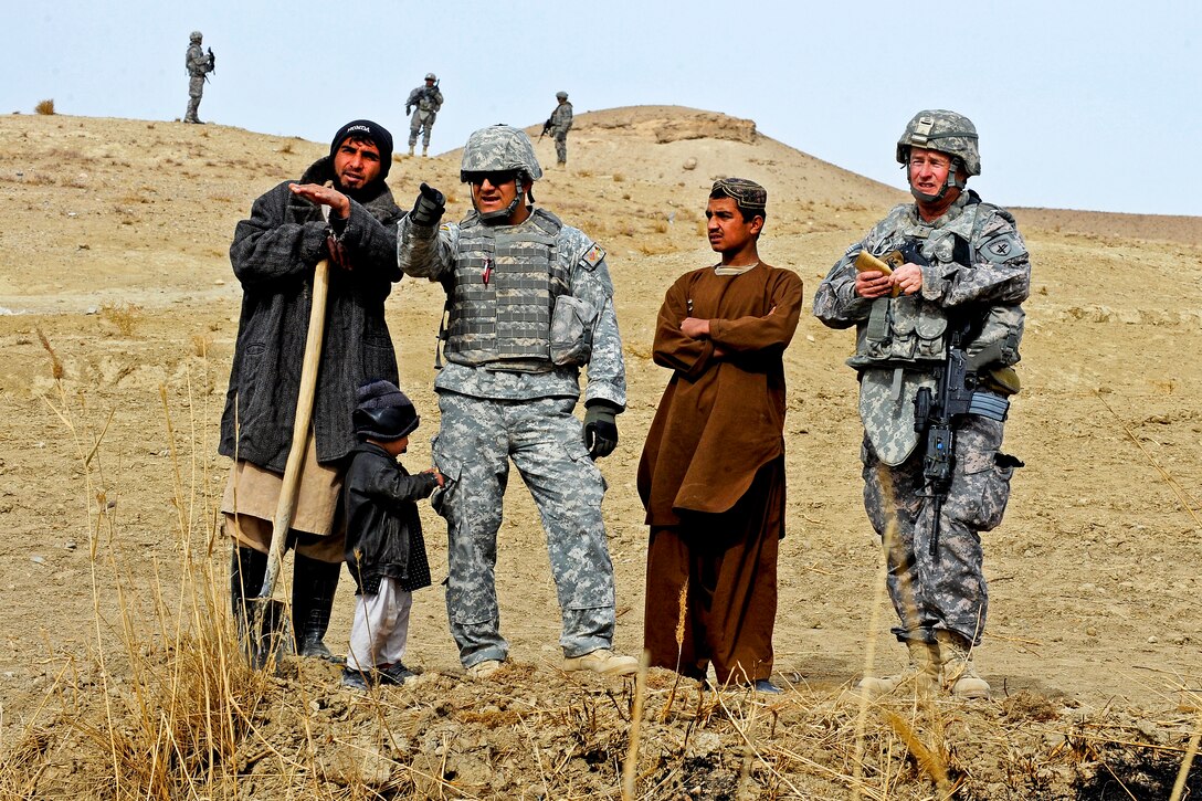 With the assistance of a linguist, U.S. Army Chief Warrant Officer ...