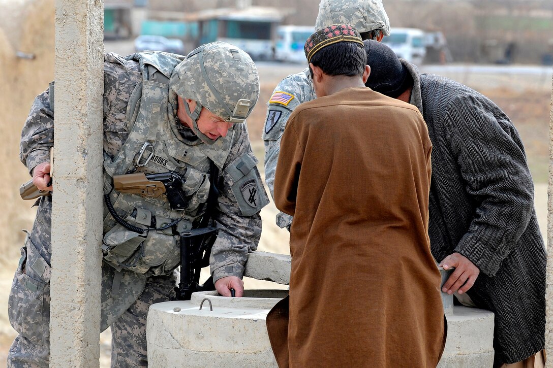 U.S. Army Chief Warrant Officer Ronald Brooks assesses a well during a ...