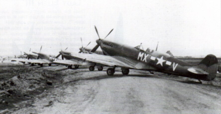 A fleet of 31st Fighter Group Spitfires lines the runway at Castel ...