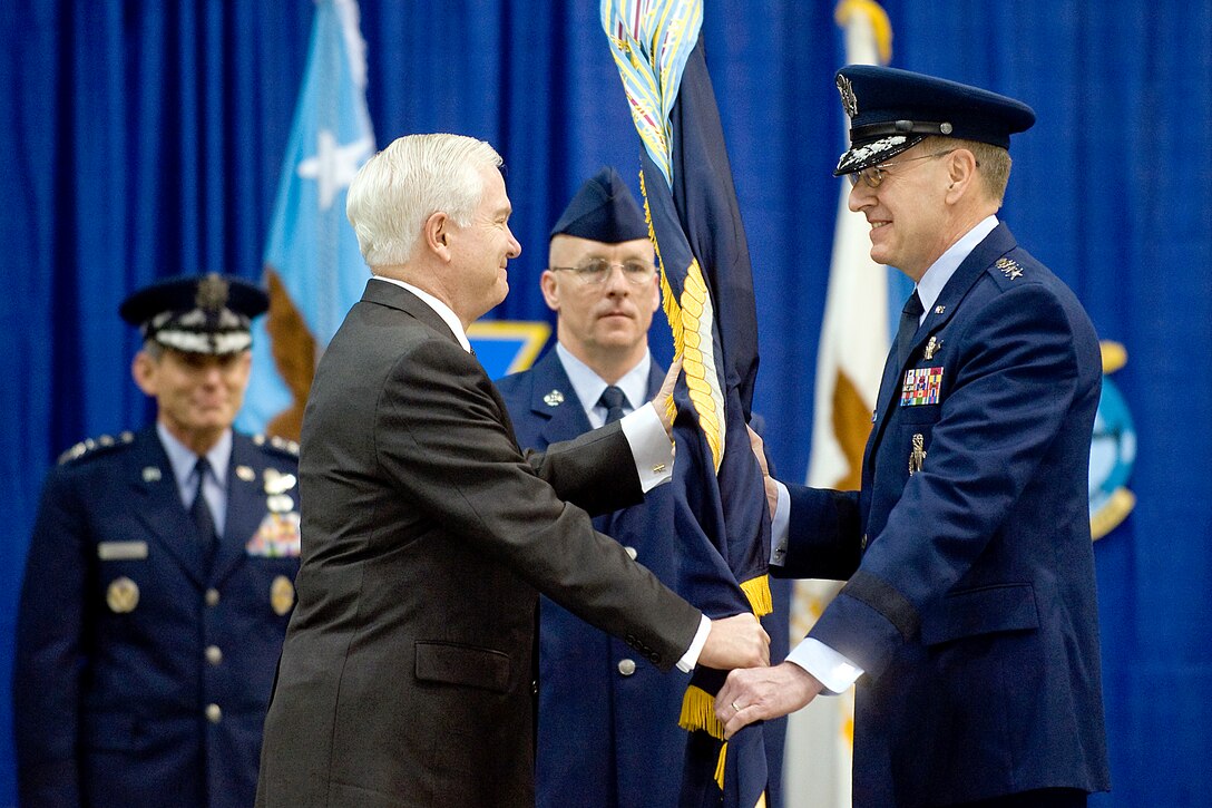 Defense Secretary Robert M. Gates passes the command flag to Air Force ...