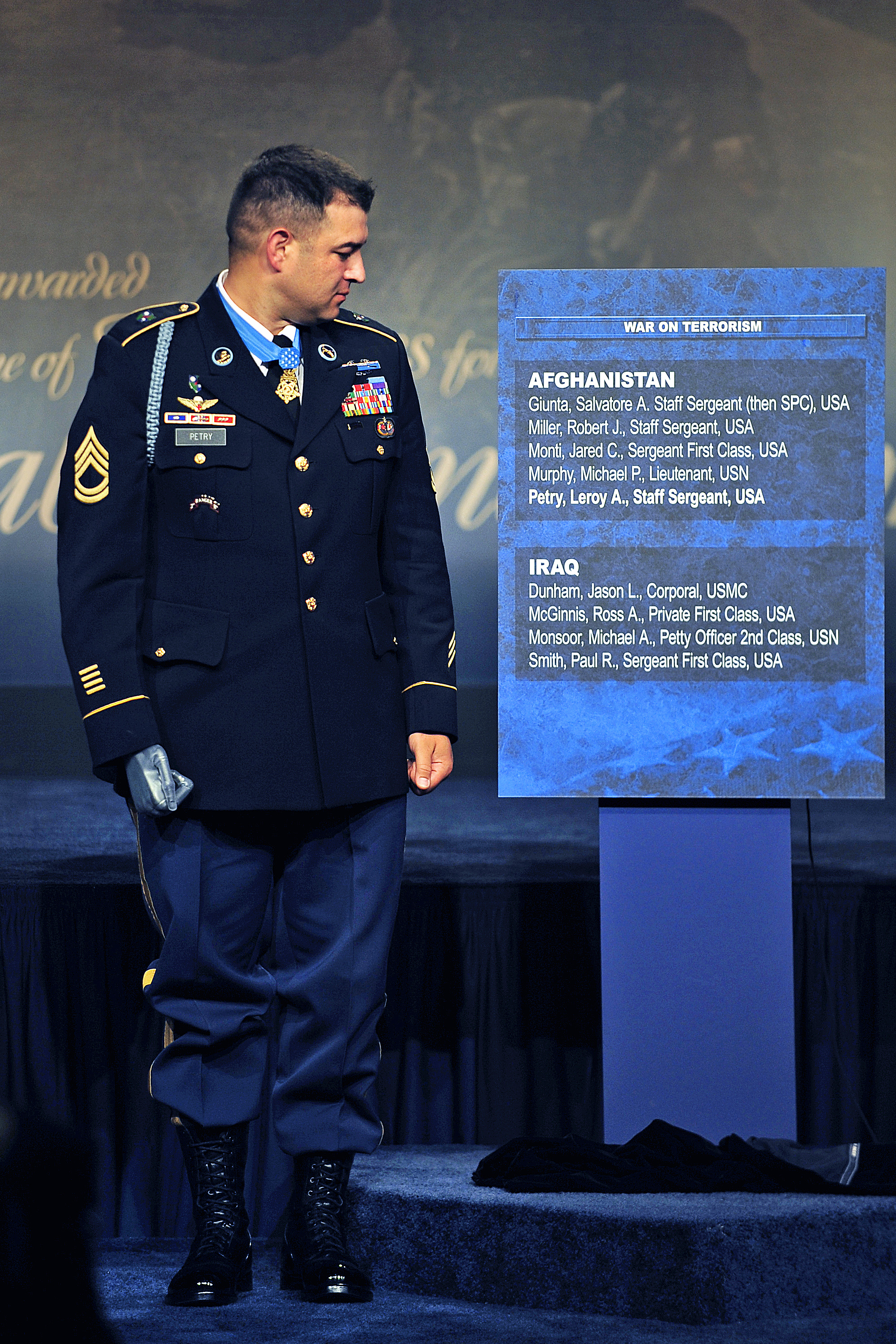 Medal of Honor recipient Army Sgt. 1st Class Leroy A. Petry stands next ...