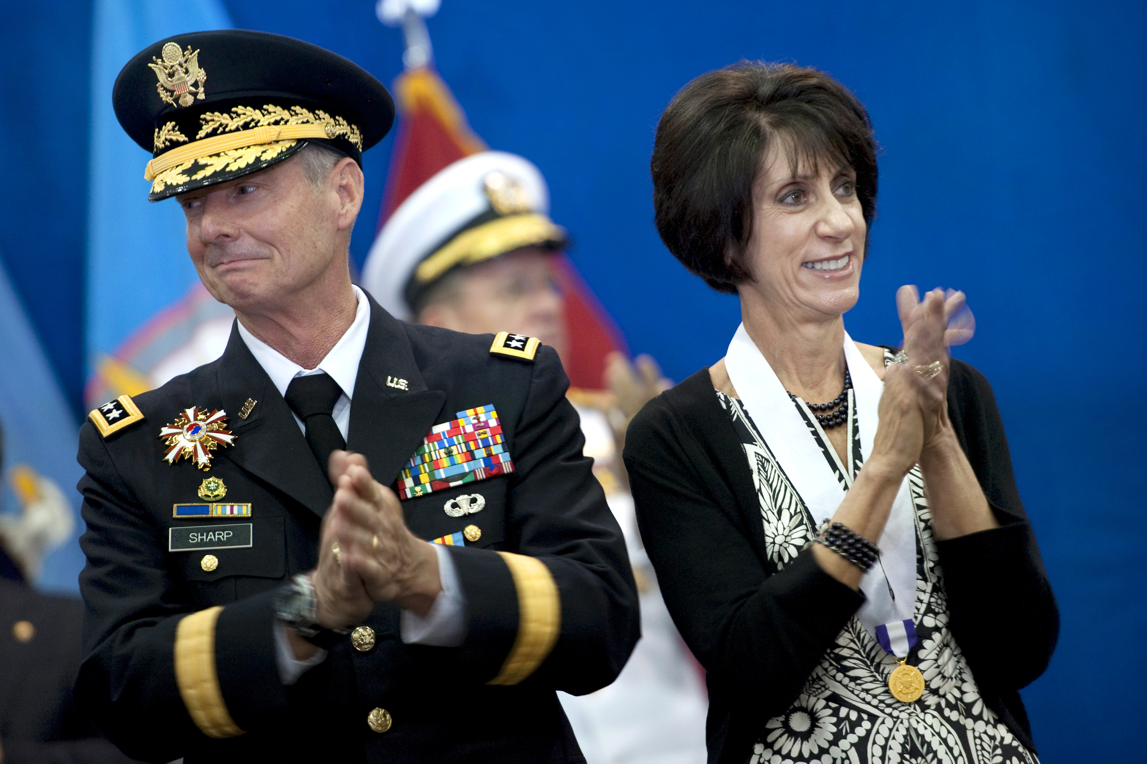 U.S. Army Gen. Walter L. "Skip" Sharp and his wife, Joanne, applaud at the conclusion of his ...