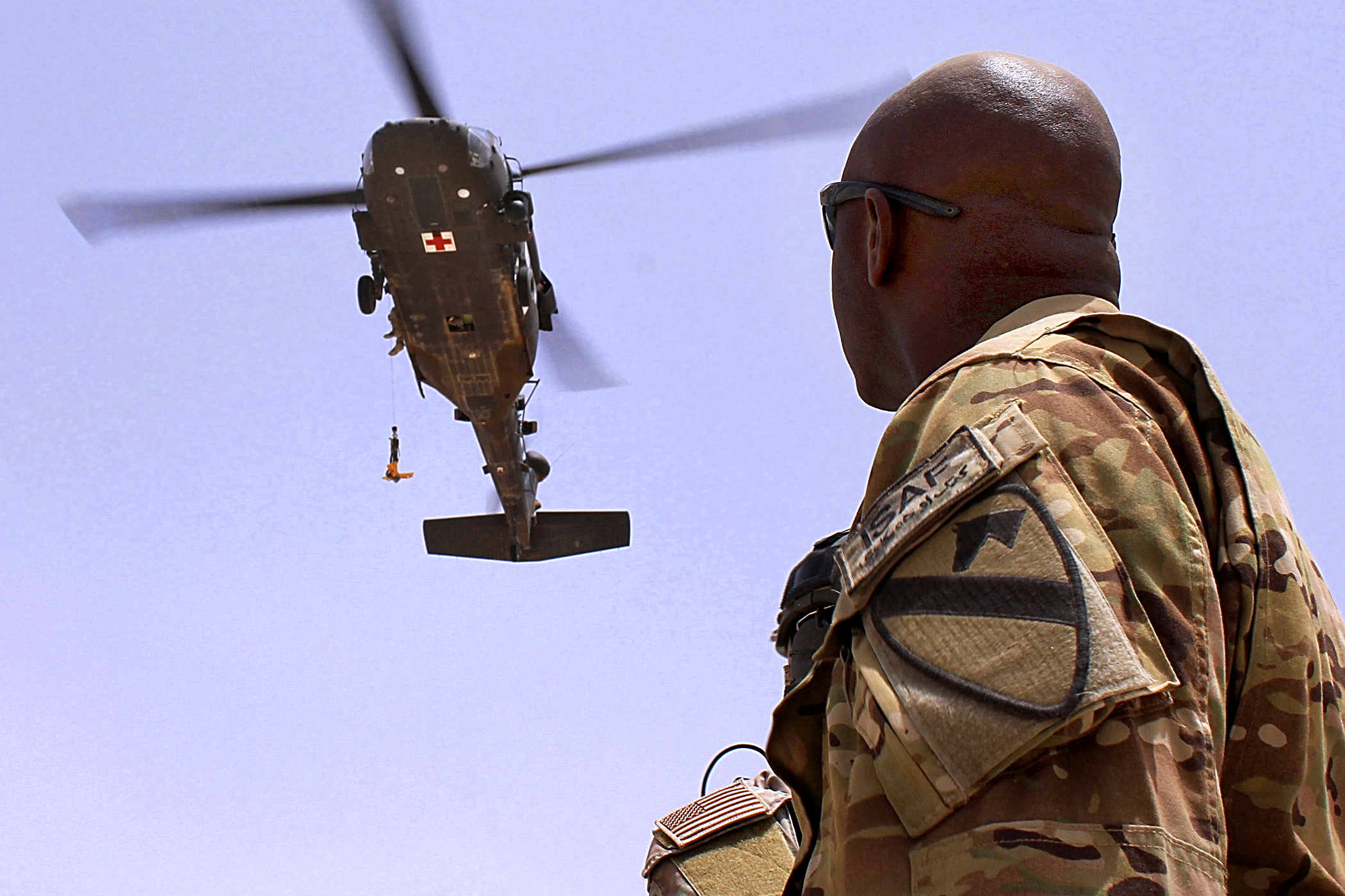 U.S. Army 1st Sgt. Gerald Brown looks on as a UH-60L Black Hawk ...