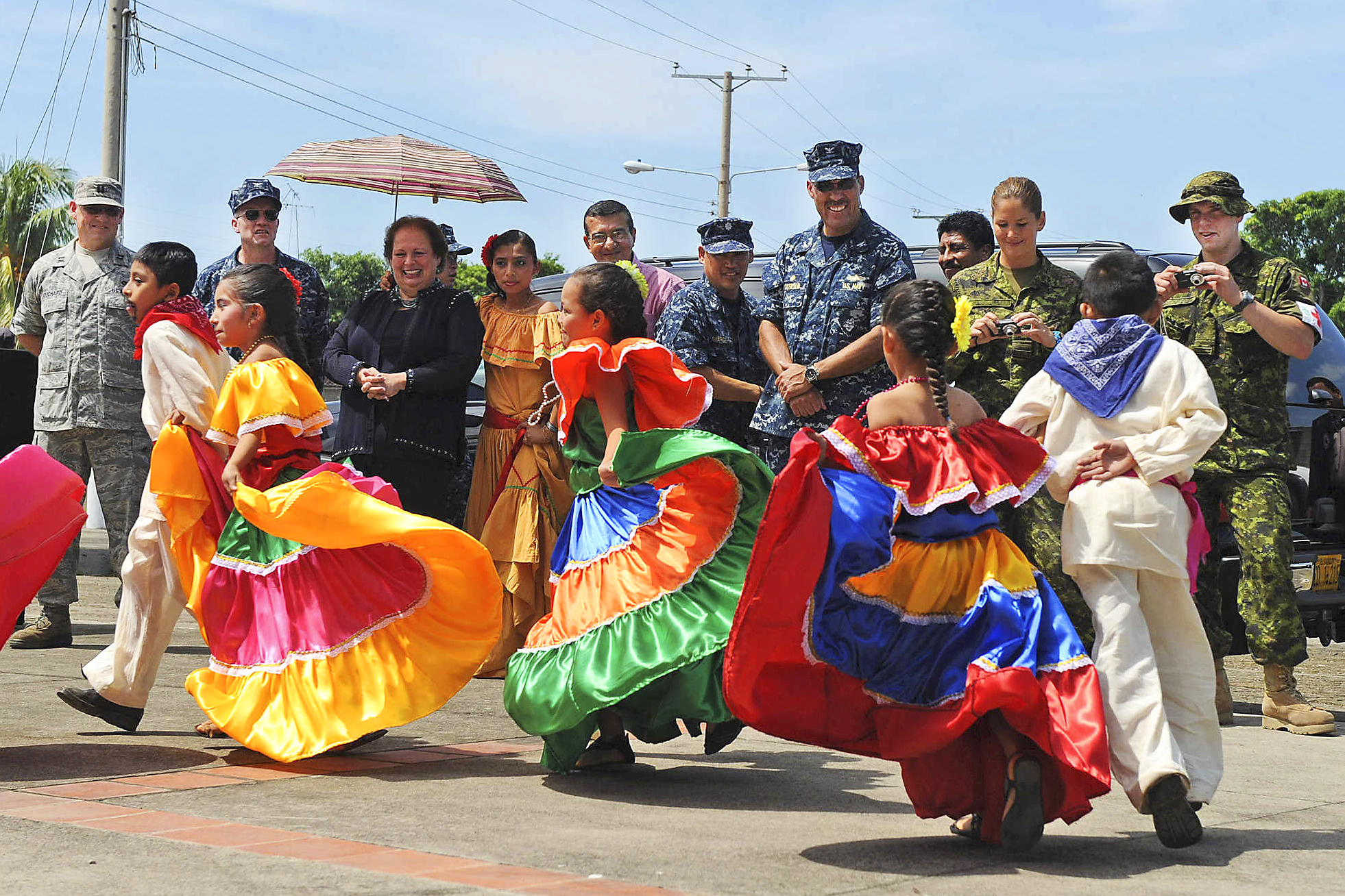 U.S. Navy Capt. Brian Nickerson watches children perform traditional ...