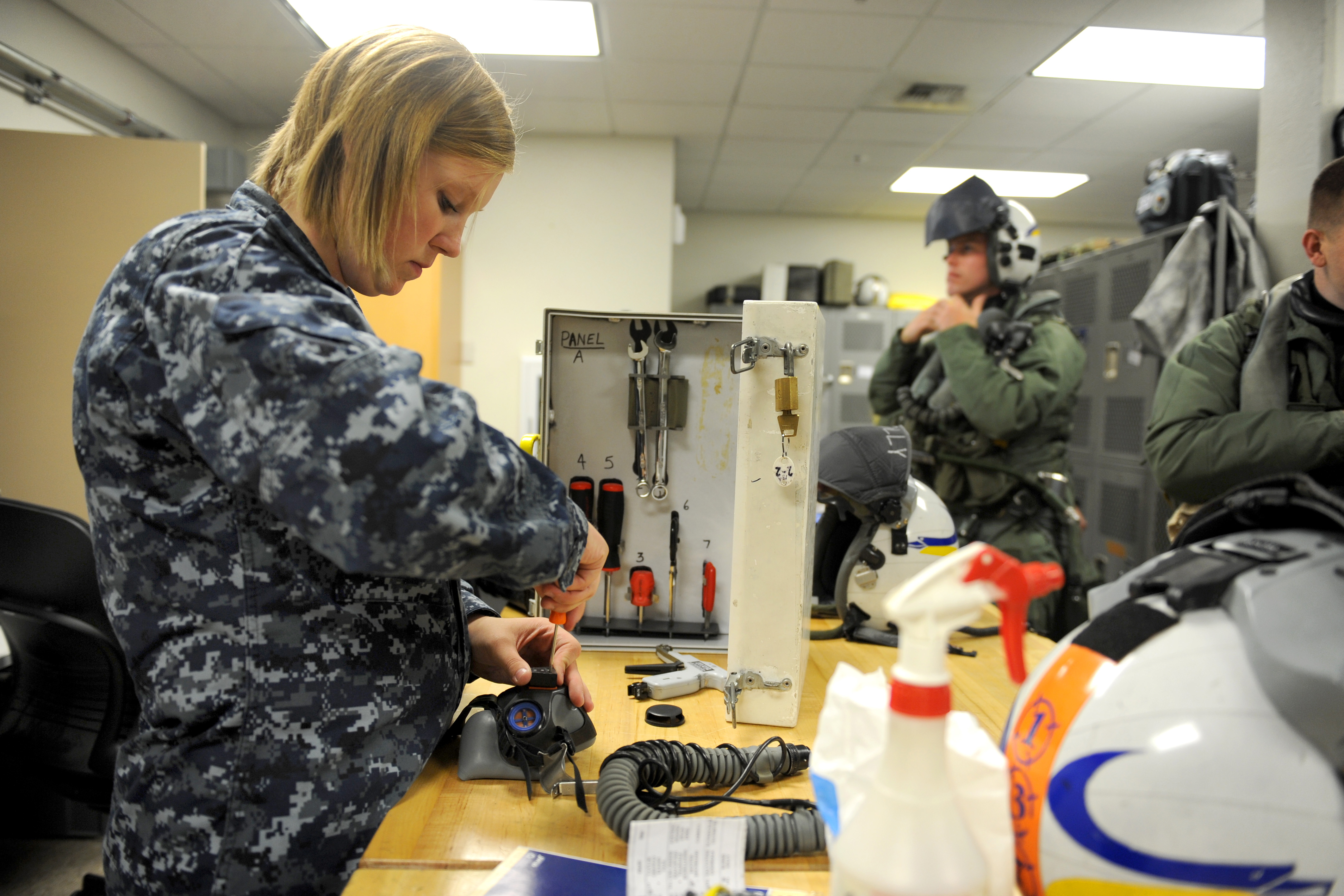 U.S. Navy Seaman Jessica Tescher performs a monthly maintenance check ...