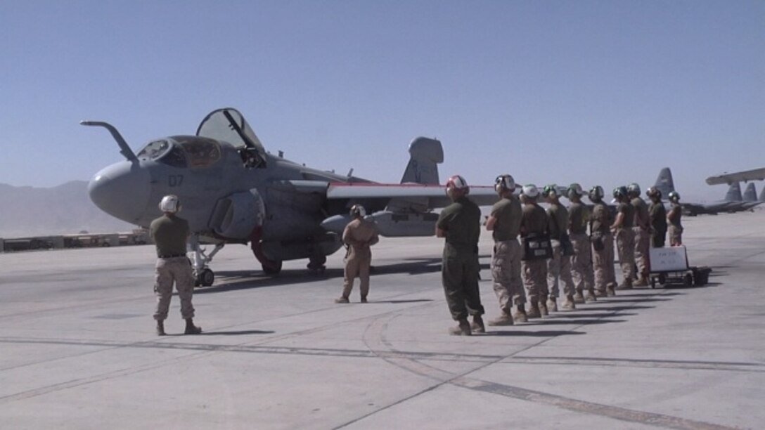 Prowler and flight line with Marines.JPG