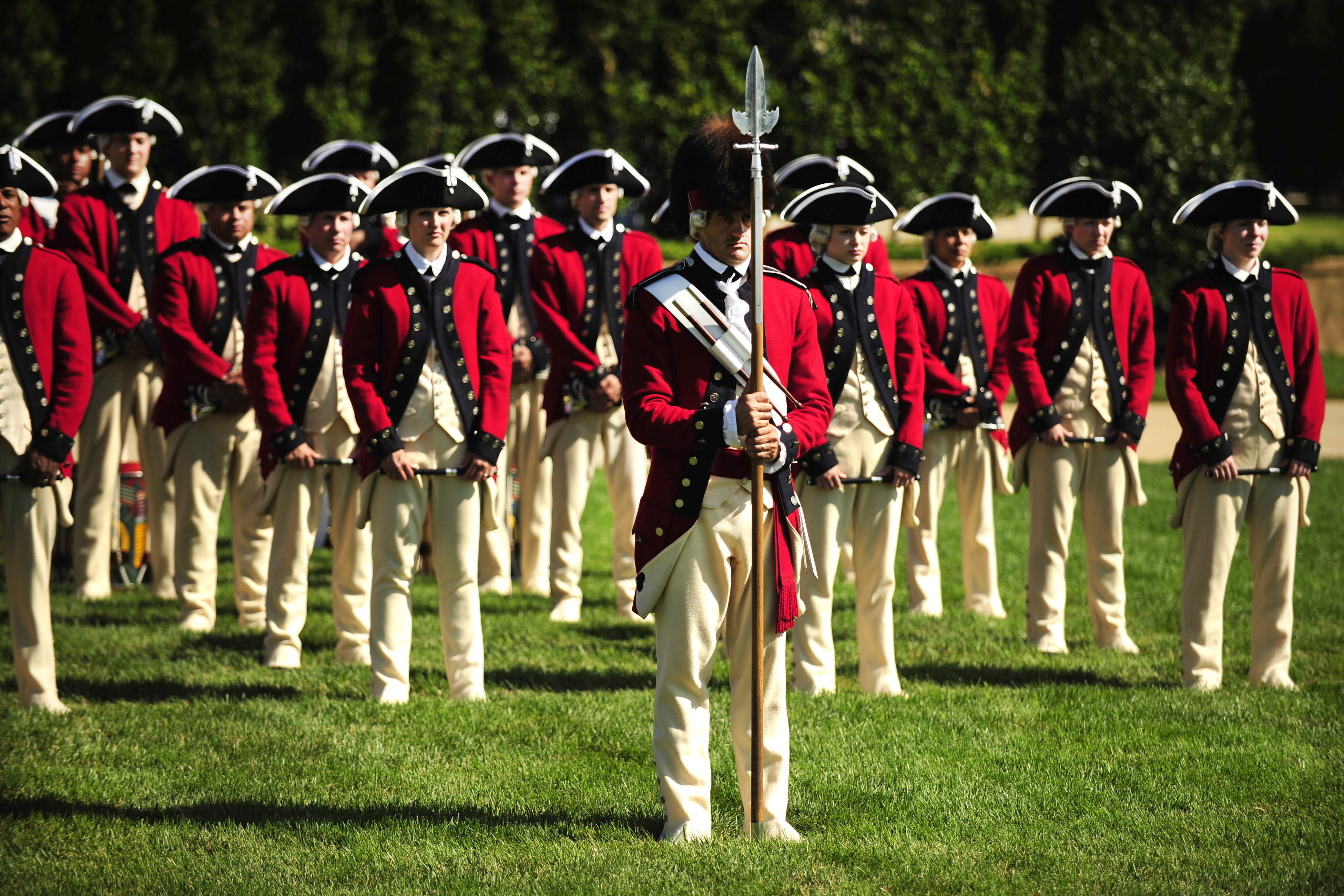 The U.S. Army Old Guard Fife and Drum Corps stand on the parade field ...