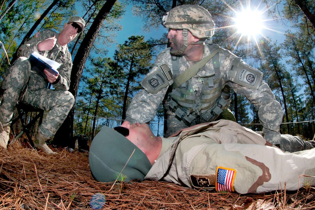 U.S. Army Sgt. 1st Class Scott Brinson assesses a soldier’s fictitious ...