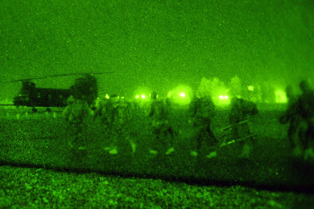 As seen through a night-vision device, U.S. Special Forces soldiers and ...