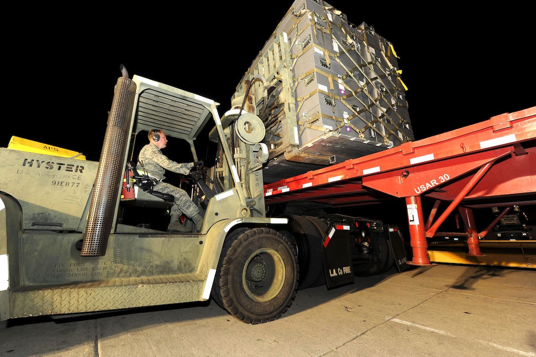 U.S. Air Force Staff Sgt. Shawn Terrault unloads a pallet using a 10K ...