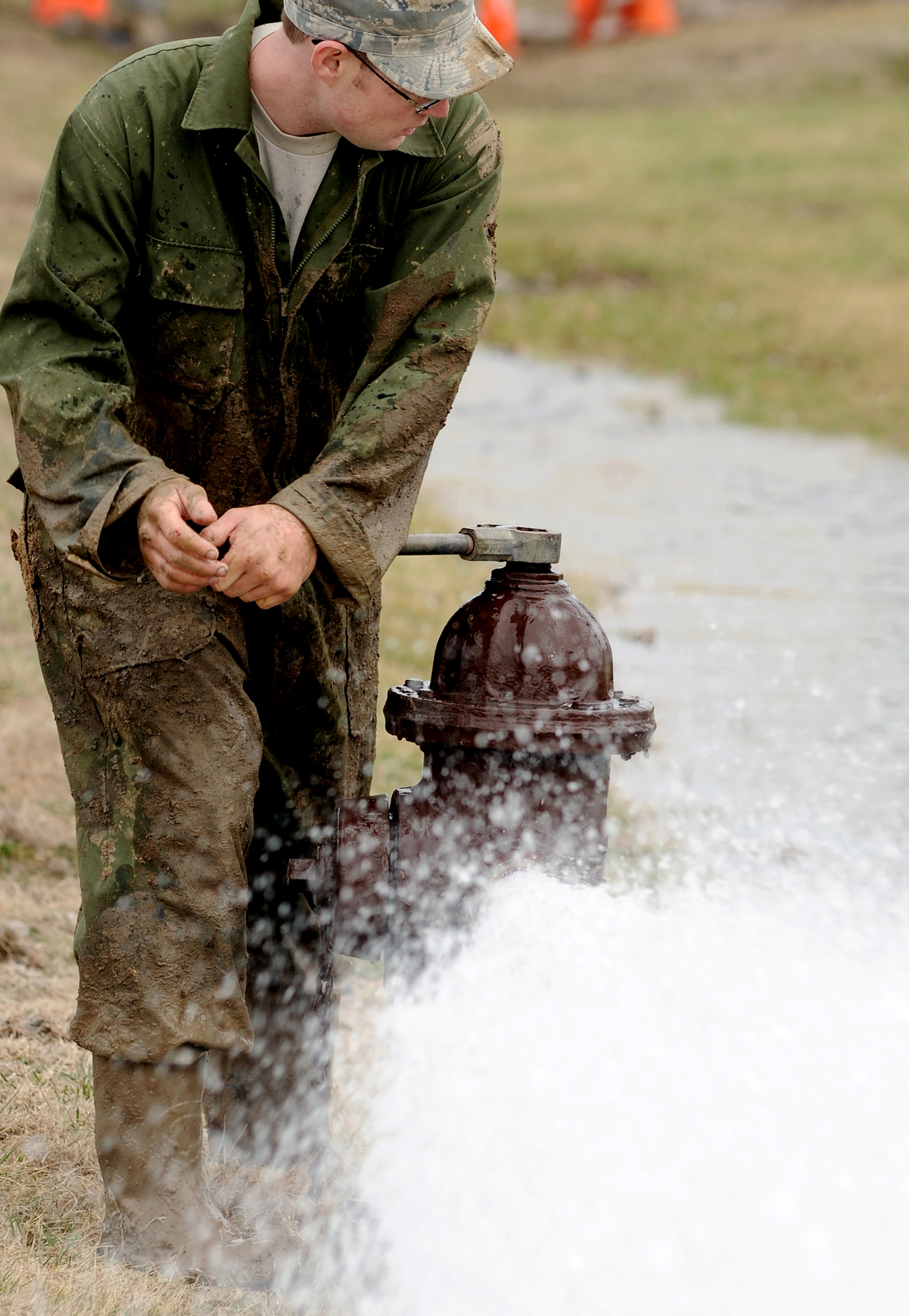 Air Force Staff Sgt. Justin England uses a fire hydrant to flush a ...