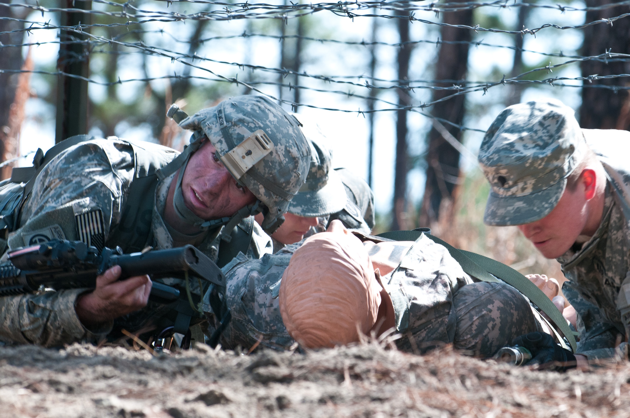 Army Pfc. Levi Meyer brings a simulated casualty through a low-wire ...