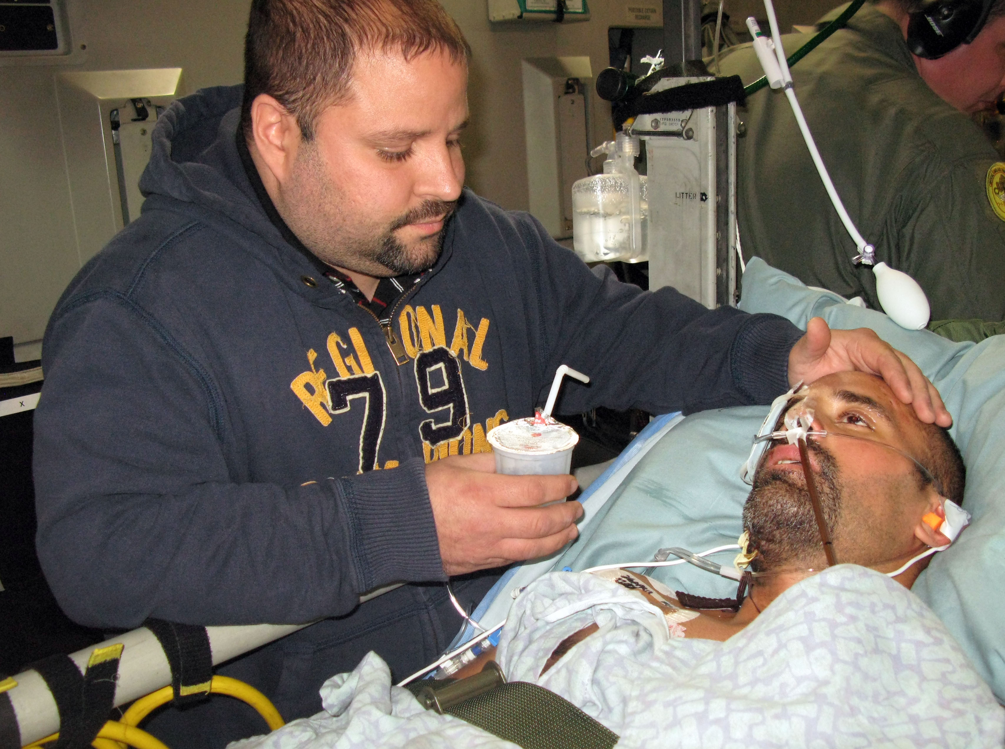 Mike Castagna, comforting his brother, Army Spc. Adam Castagna, during ...