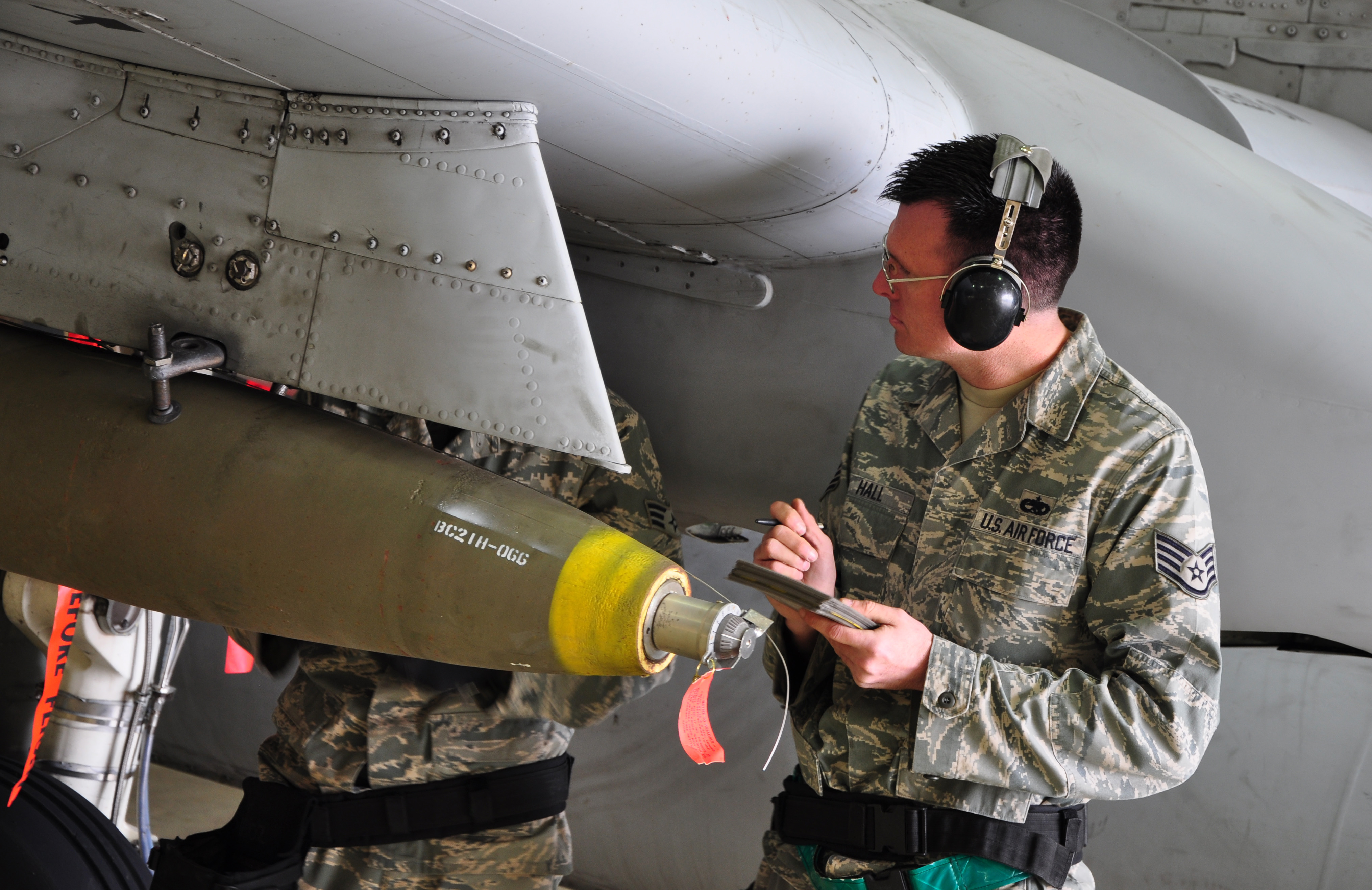 Bombs away: Airmen work together to build, load munitions