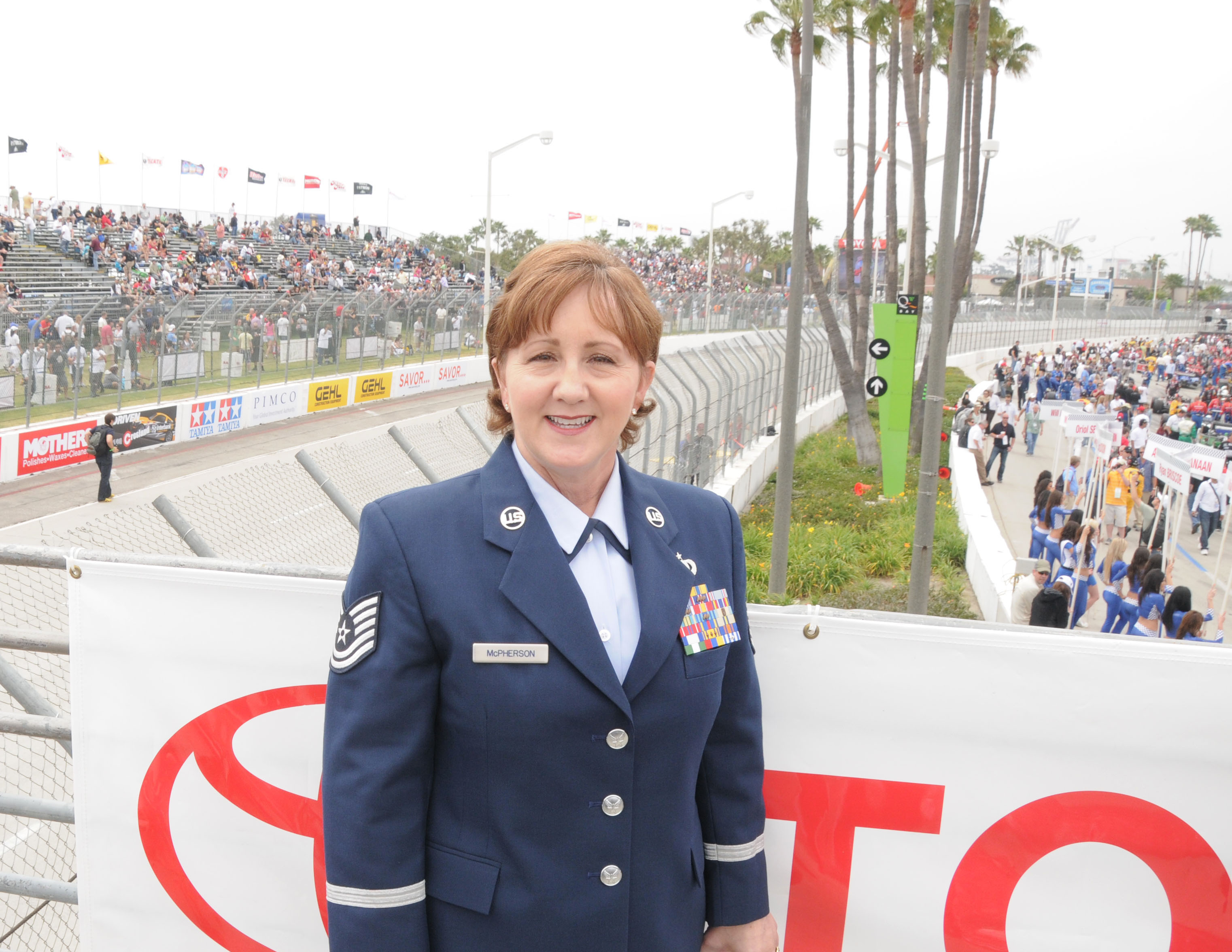 Tech. Sgt. Erin McPherson sings the National Anthem at the Toyota Grand ...