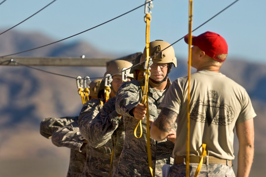 U.S. Air Force Tech. Sgt Steven Clement, right, guides an airborne jump ...