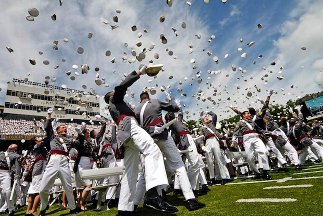 The Class of 2011 takes part in the traditional hat toss after being ...