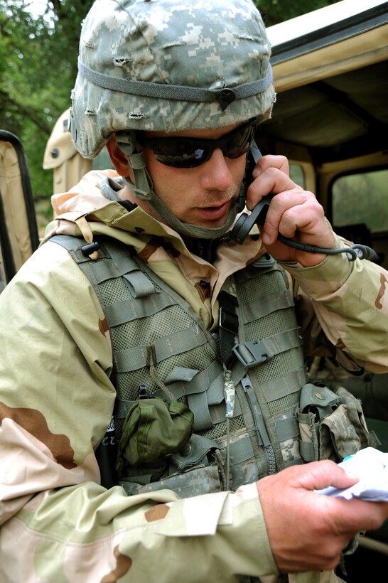 An Army soldier uses a radio to call in a report duing exercises to ...