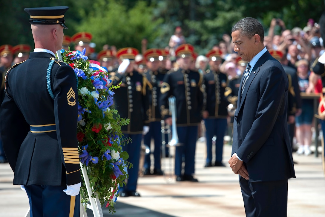 President Barack Obama bows his head in a moment of silence after ...