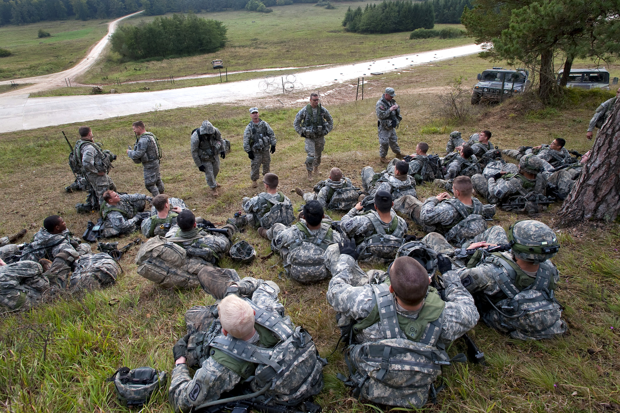 U.S. Army observer-controllers discuss a completed training scenario ...