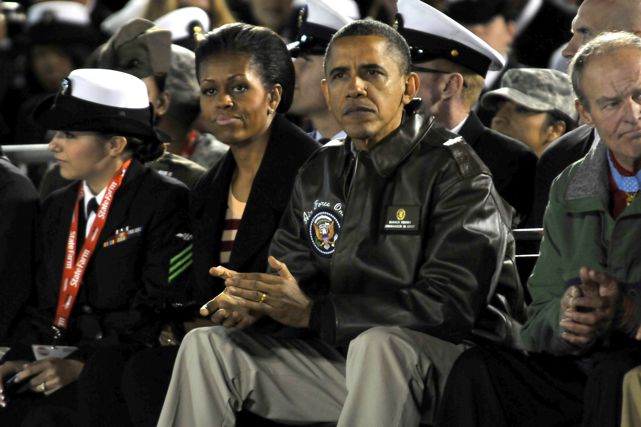 President Barack Obama and First Lady Michelle Obama sit amognst ...