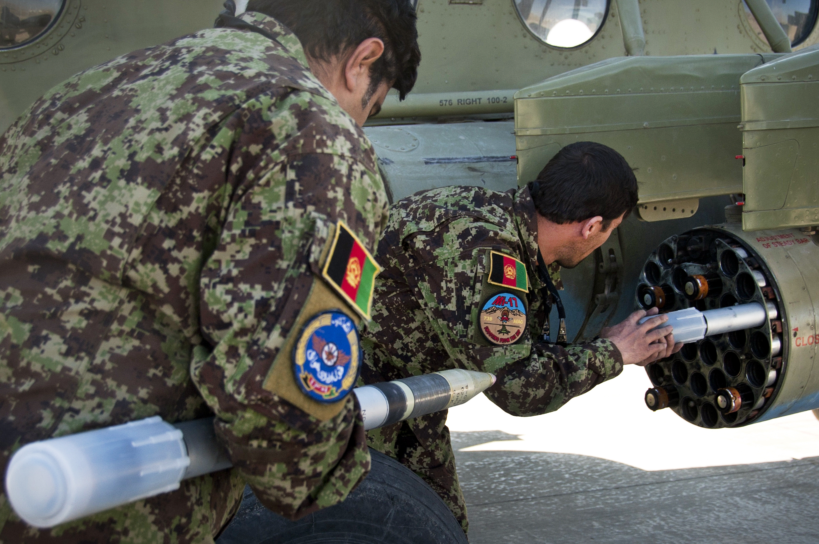 Afghan airmen load a Mi-17 helicopter with 57 mm S5 rockets on Kandahar ...