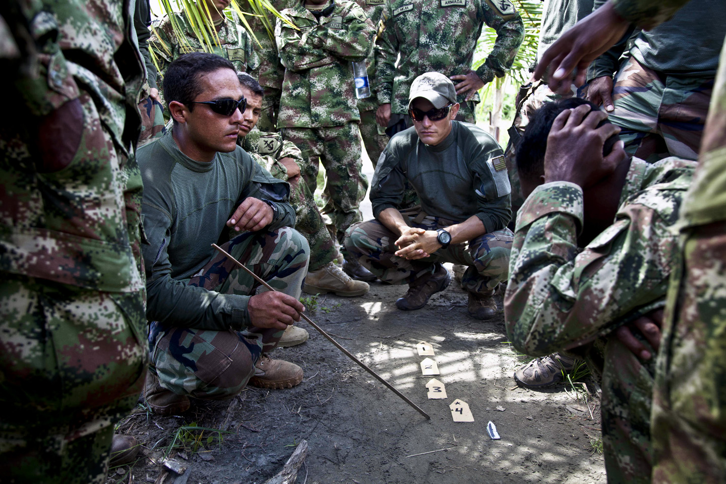 U.S. Navy sailors and Colombian marines conduct a mission brief before ...