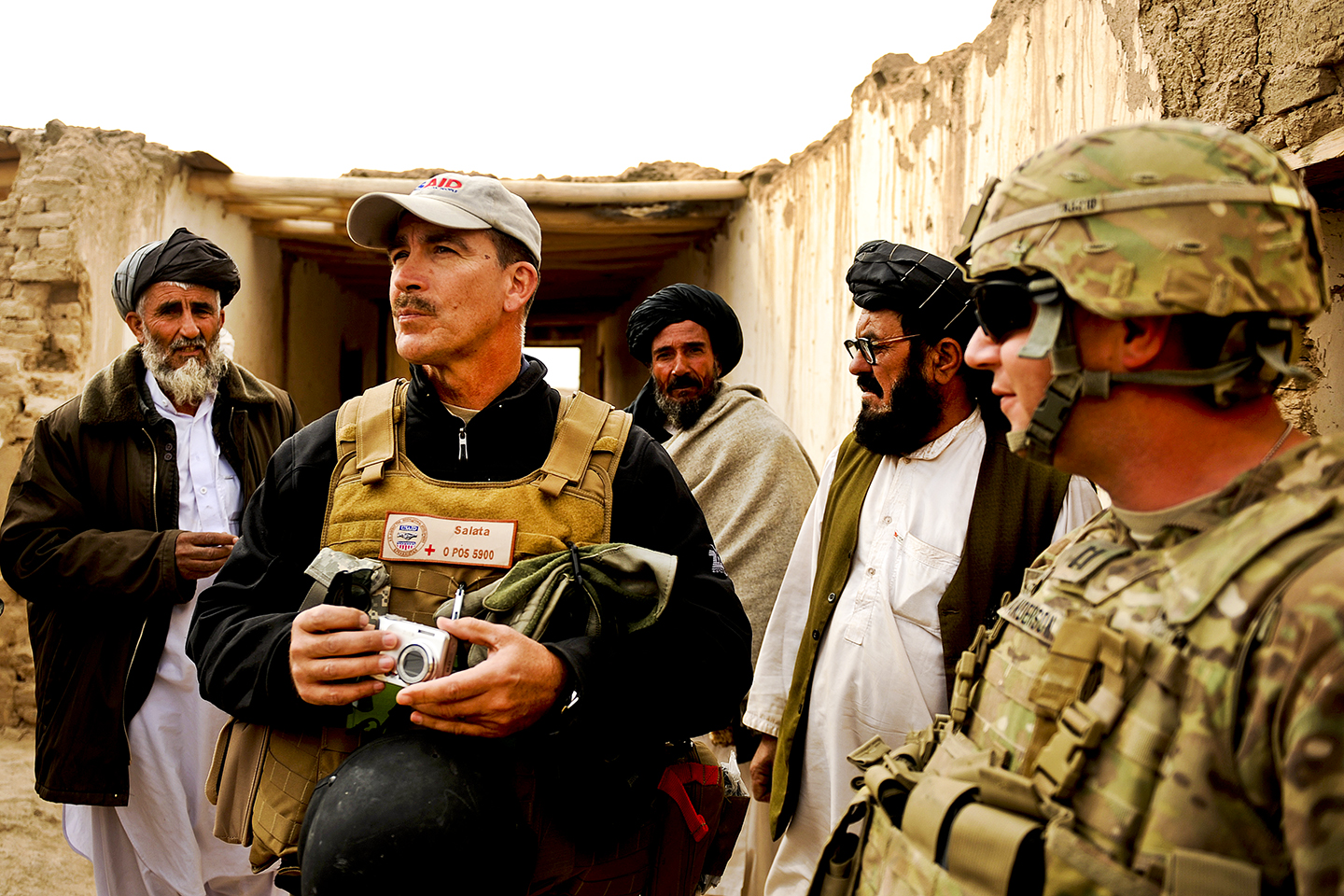 John Salata, center, and U.S. Army Capt. Michael Anderson, right ...