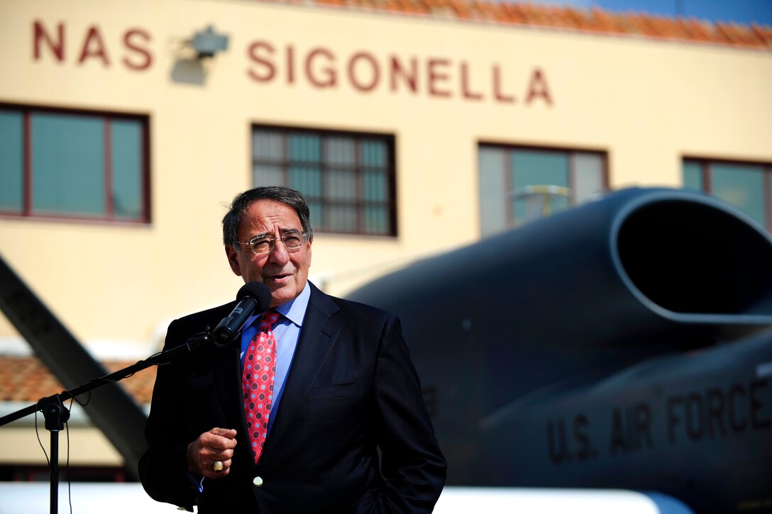 U.S. Defense Secretary Leon E. Panetta stands in front of a RQ-4 Global ...