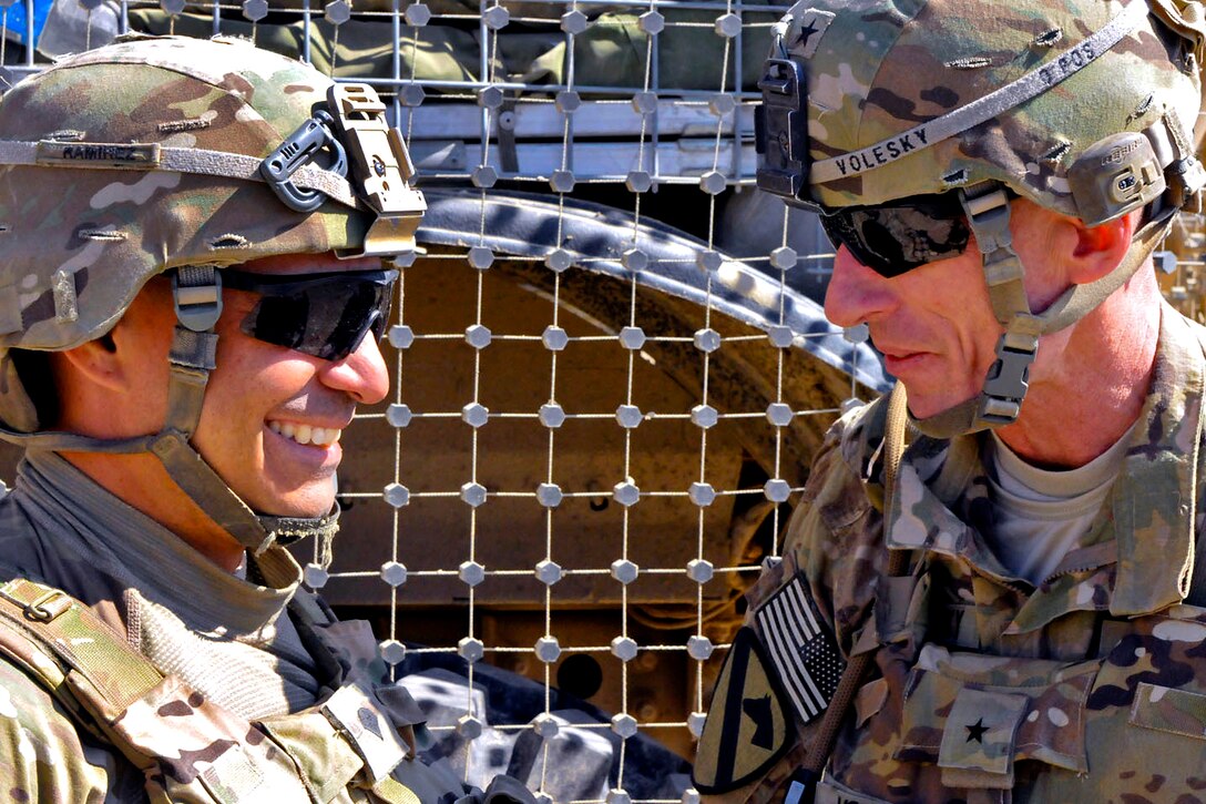 U.S. Army Brig. Gen. Gary Volesky, right, shares a laugh with U.S. Army Spc. Gabriel Ramirez ...