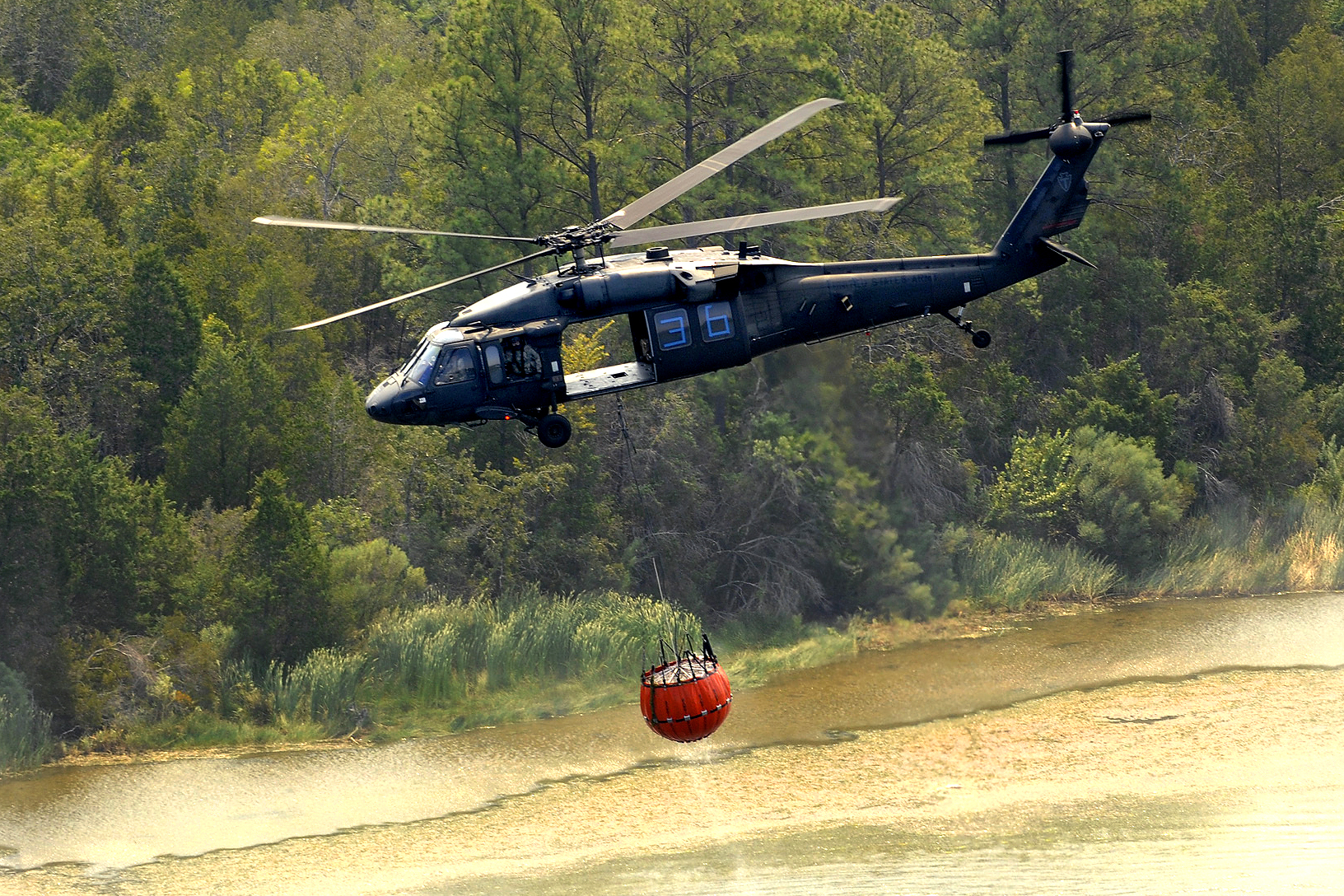 Texas Army National Guard soldiers aboard a UH-60 Black Hawk helicopter ...