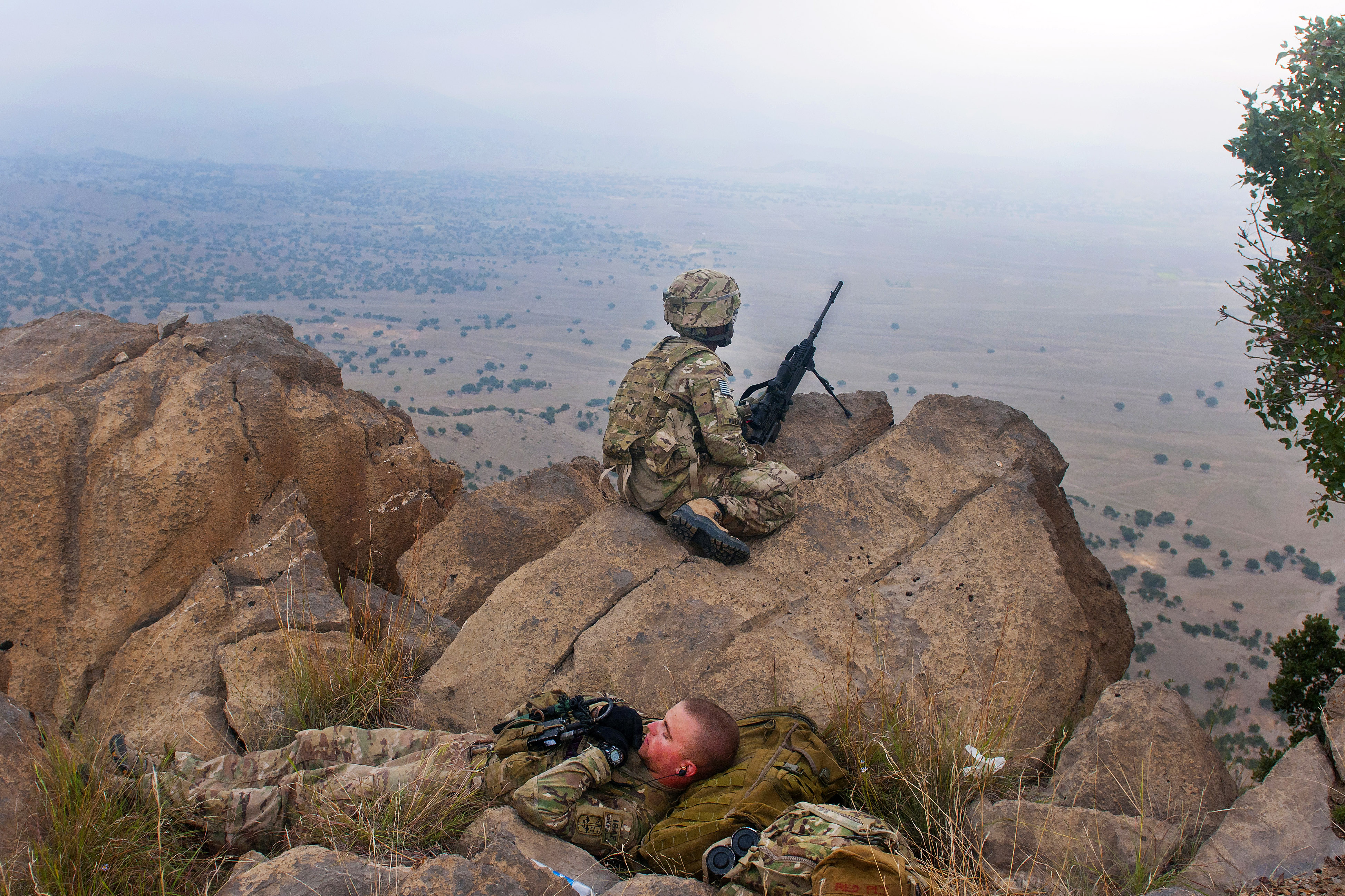 U.S. Army sniper Spc. James Wanser keeps watch in the early morning ...