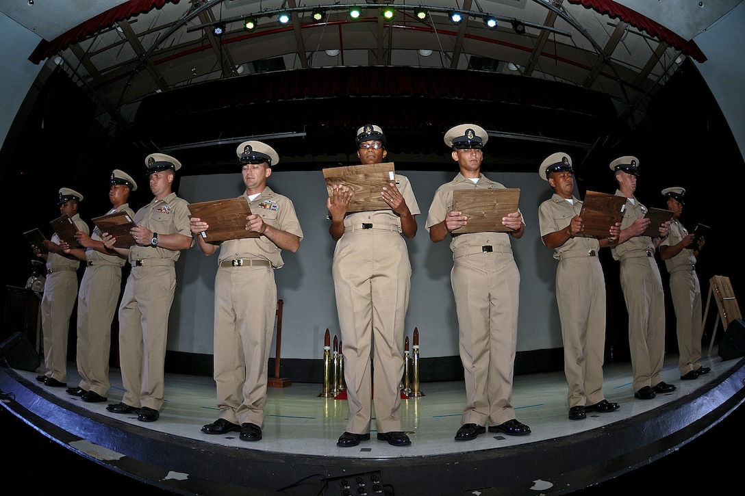 Newly-pinned U.S. Navy chief petty officers listen to the "Chief Petty ...