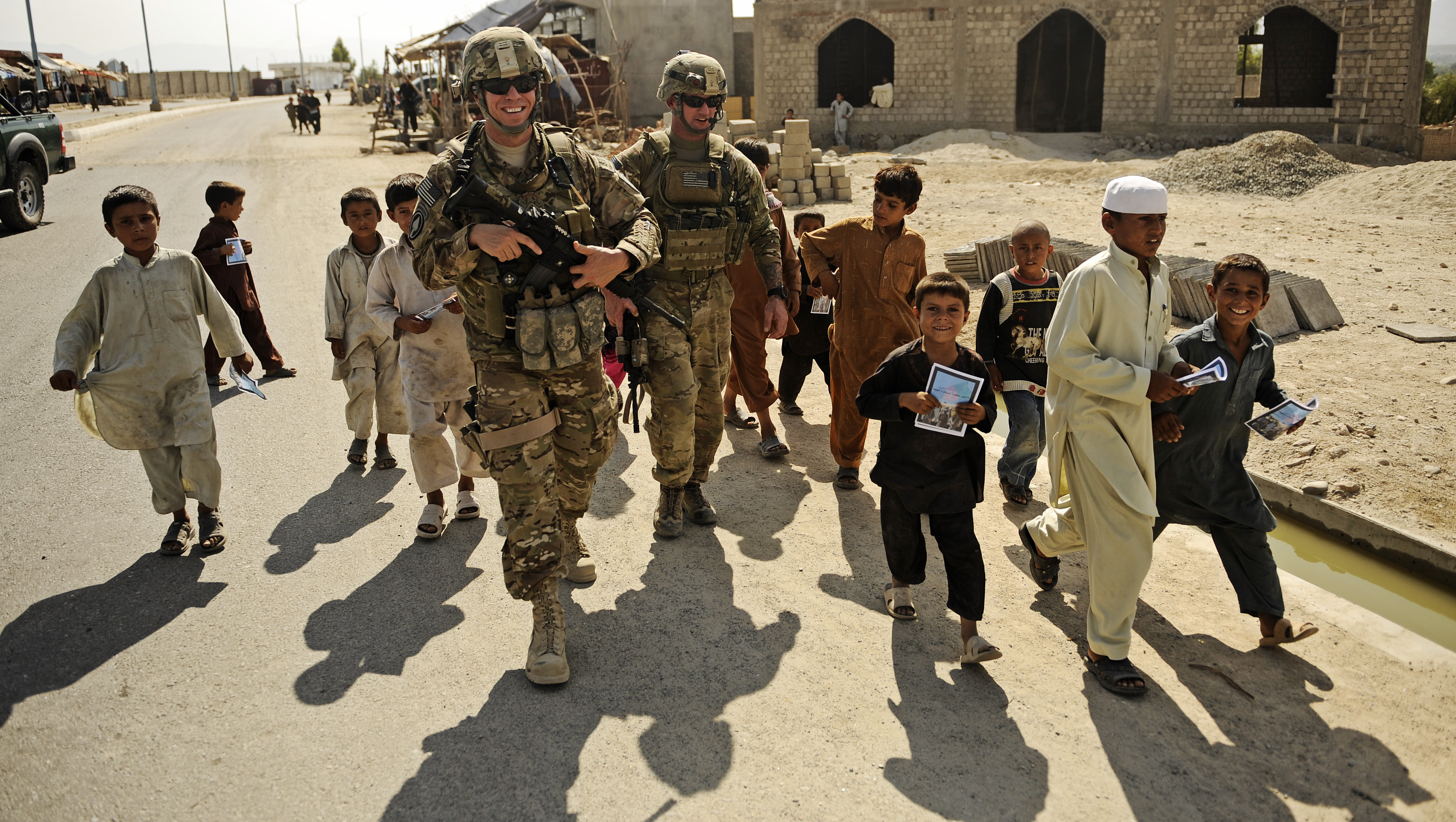 U.S. Army Capt. Brandon Delatorre and Staff Sgt. Jason Roberts walk and ...