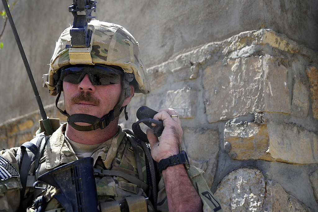 U.S. Army Sgt. Peter Lescord relays information over the radio while on ...