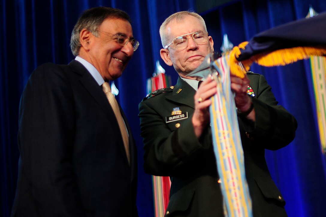 Defense Secretary Leon E. Panetta, left, affixes the Joint Meritorious ...