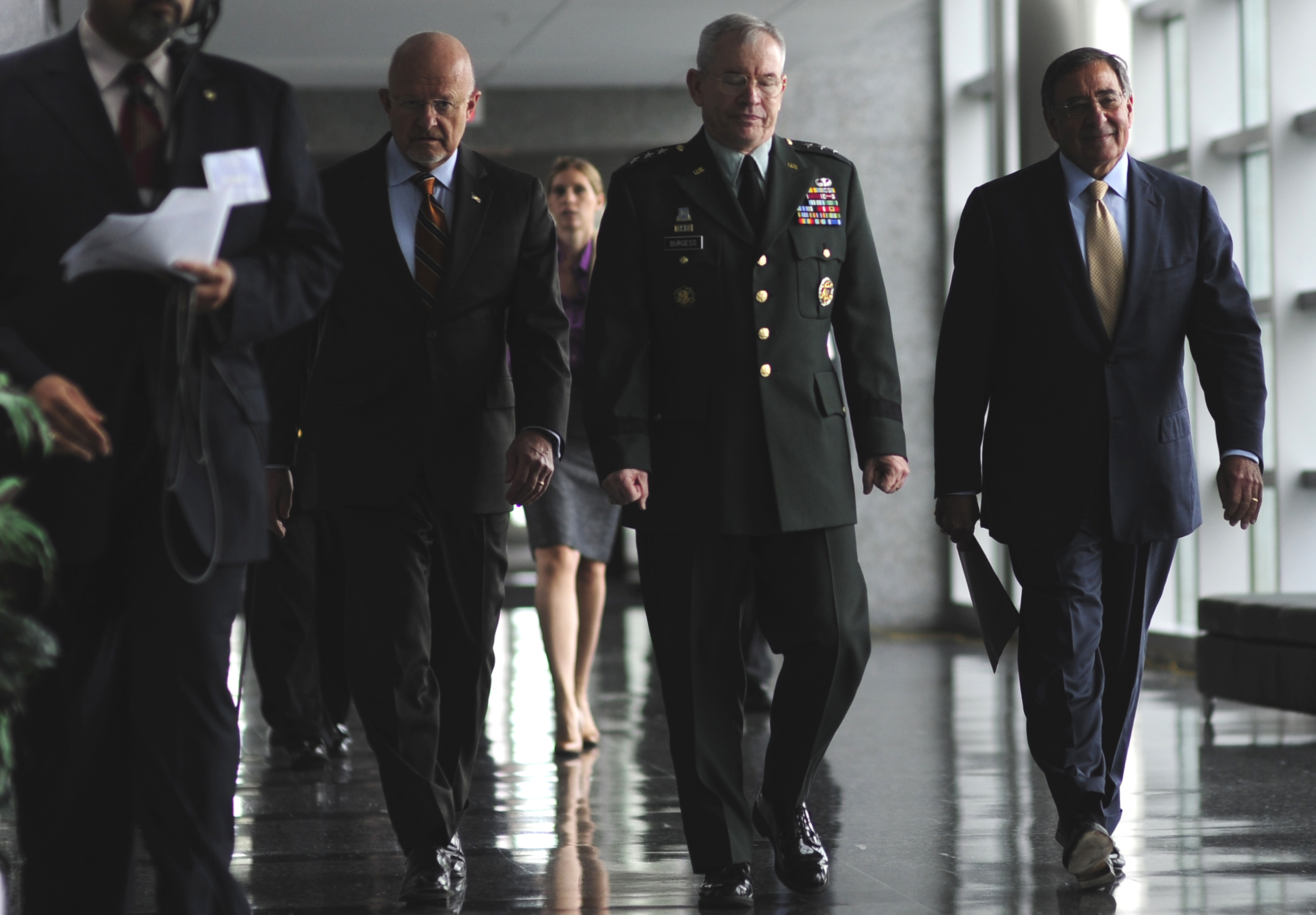 Defense Secretary Leon E. Panetta walks with James Clapper Jr., left ...