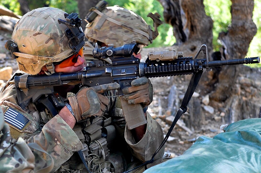A U.S. Army soldier uses the scope on his weapon to scan the Waygul ...