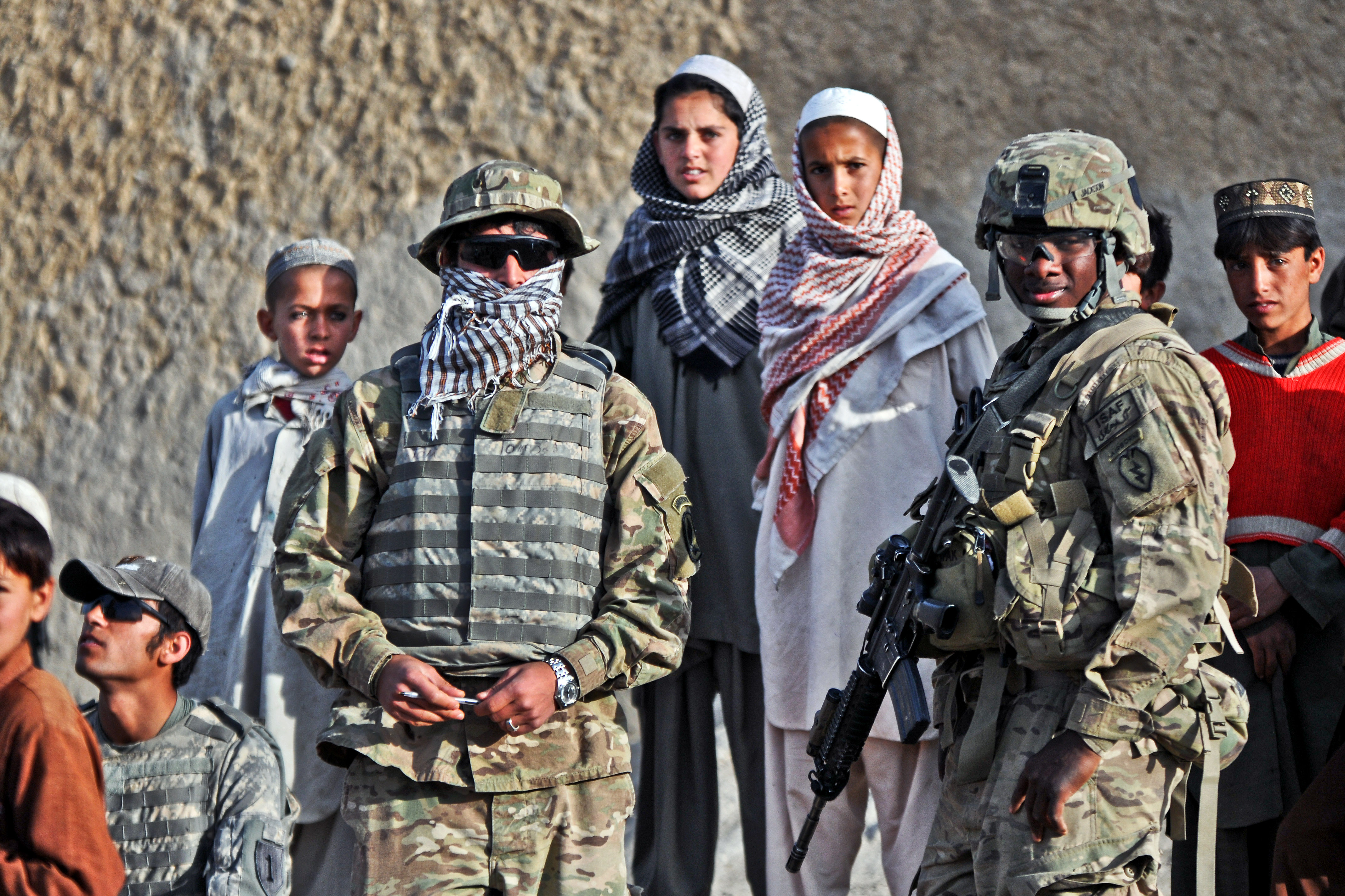 U.S. Army Spc. Devon Jackson, left, and an interpreter, interact with ...